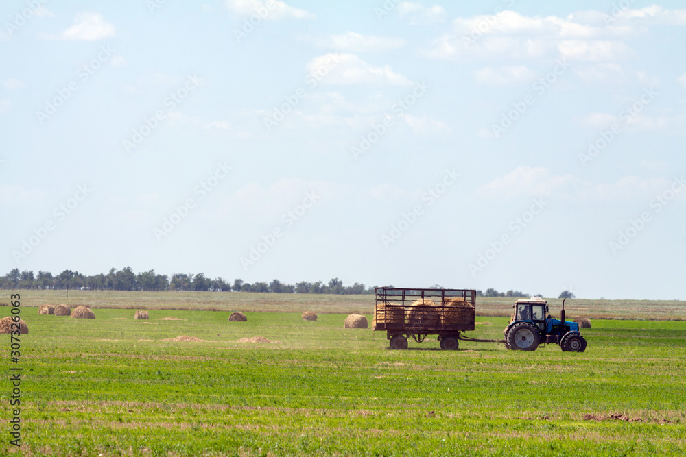 Tractor loading hay bales on truck agricultural works Stock Photo ...