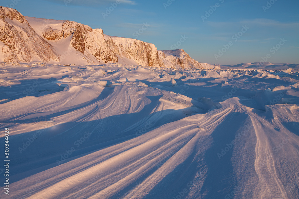 Winter landscape with sastrugi on the snow (traces of wind erosion on ...