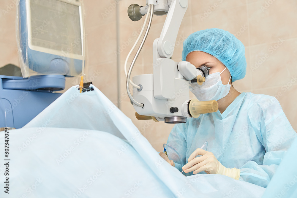 Ophthalmology laser microscope operation. Doctor in clinic. Patient eye ...
