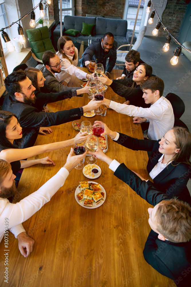 Happy co-workers celebrating while company party and corporate event ...