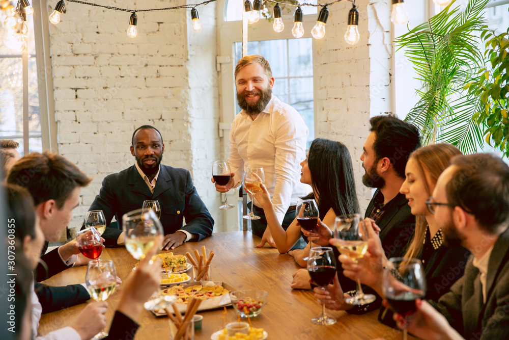 Happy co-workers celebrating while company party, corporate event ...