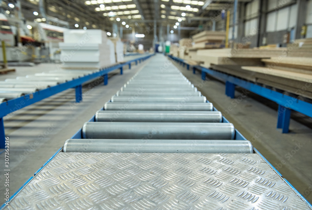 An empty industrial roller conveyor belt in a fully automated factory ...