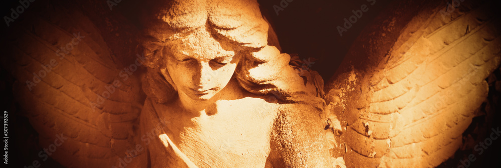 Beautiful facial expression of an ancient statue of guardian angel ...