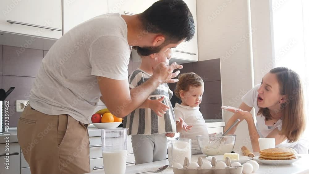 Adorable family cooking together in the kitchen with modern interior ...