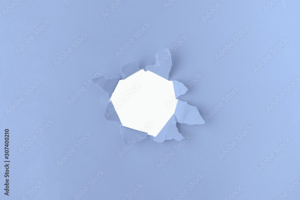 isolated piece of paper with a torn, cracked hole on it, copy space ...