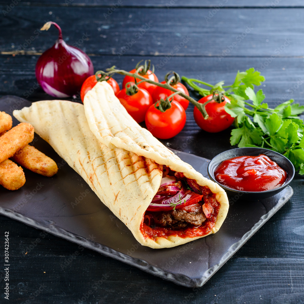 Doner kebab (shawarma or doner wrap). Grilled chicken on lavash (pita ...