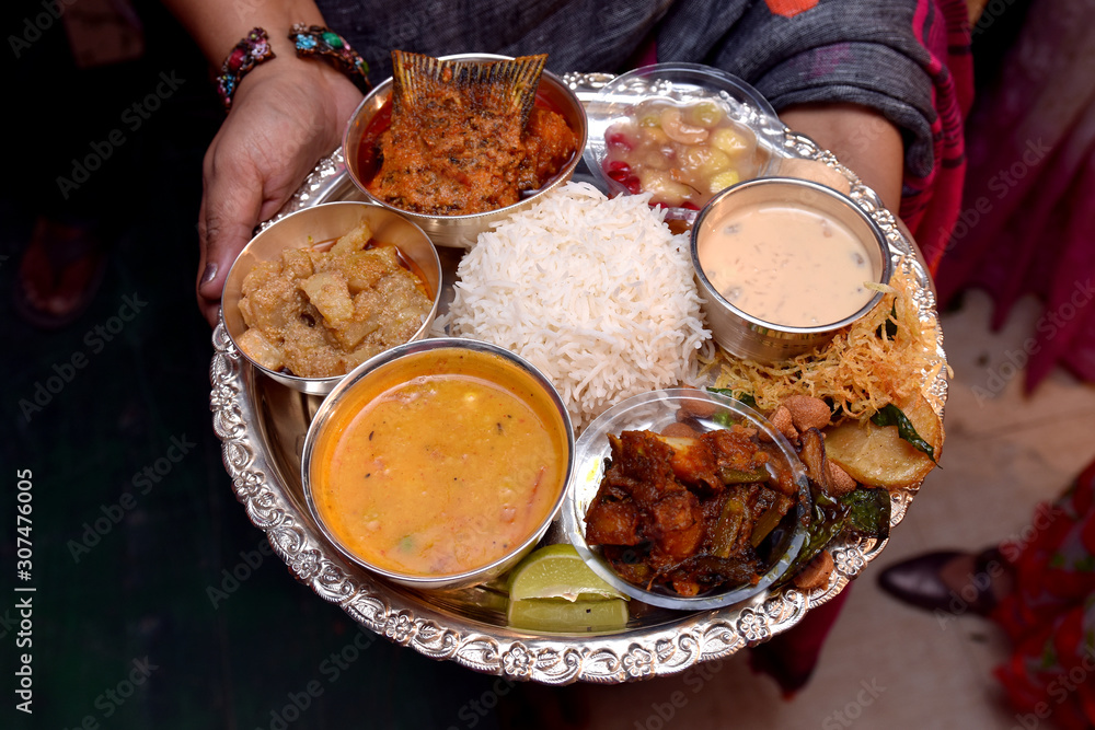 Newly married husband and wife exchanging Traditional Indian food Thali ...