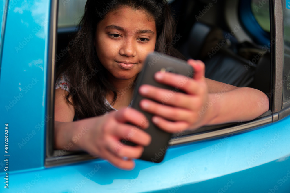 Teenage girl browsing smart phone Stock Photo | Adobe Stock