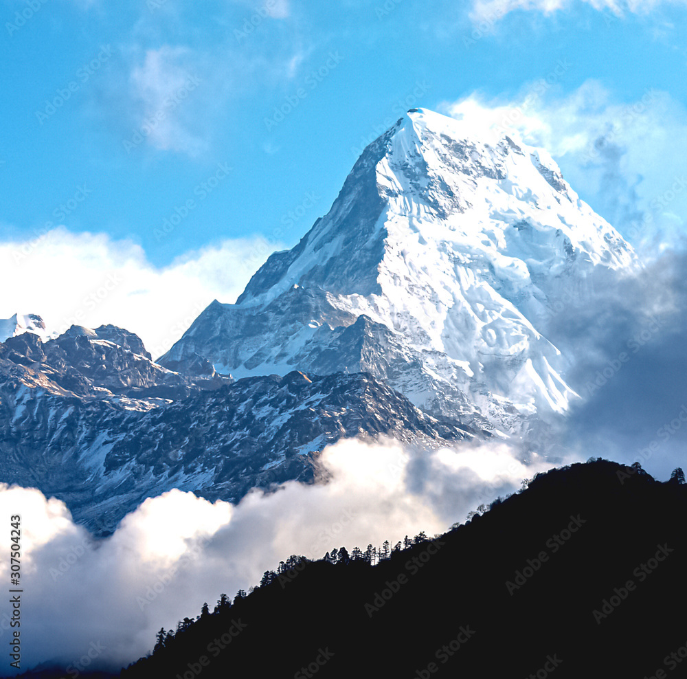Amazing autumn panorama with mountains covered with snow and forest ...