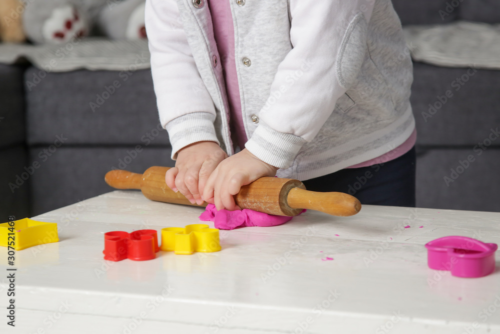 Toddler girl playing with modelling clay. Play dough allows kids to ...