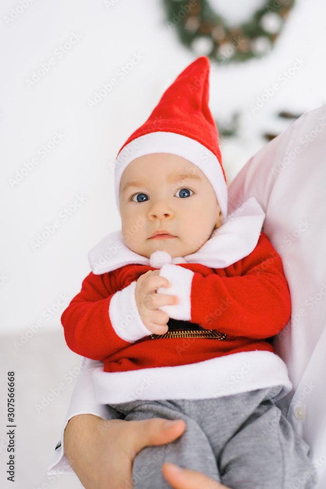 Funny little boy in Santa costume is ready to celebrate Christmas and ...