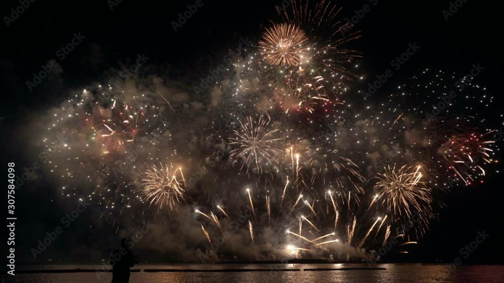 Golden big shiny fireworks with bokeh lights in the night sky. Glowing ...
