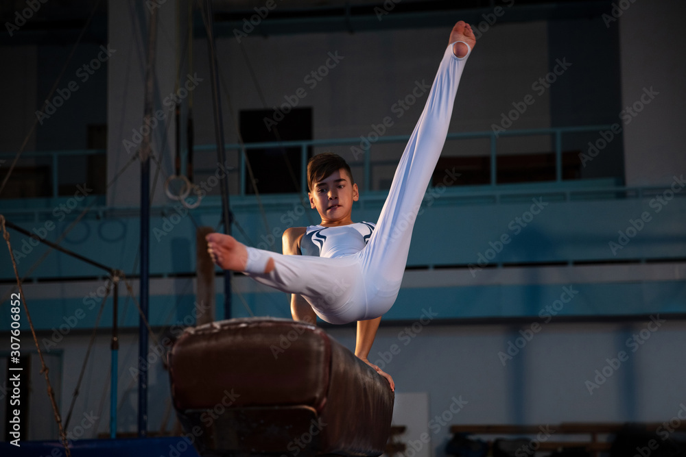 Little male gymnast training in gym, flexible and active. Caucasian fit ...