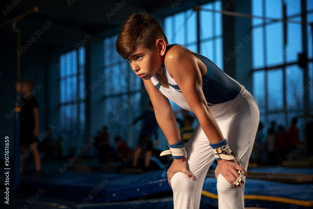 Little male gymnast training in gym, flexible and active. Caucasian fit ...