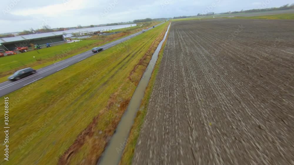 Drone following a car on a busy main road going through a rural area ...