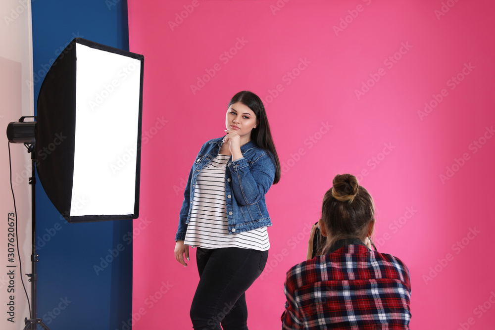 Photographer taking picture of overweight woman in studio. Plus size ...