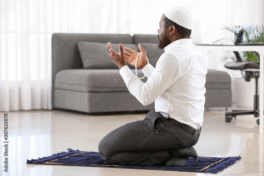 African-American Muslim man praying in office Stock Photo | Adobe Stock