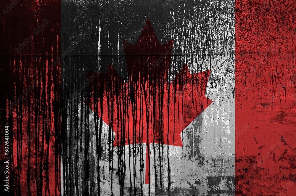 Canada flag depicted in paint colors on old and dirty oil barrel wall ...