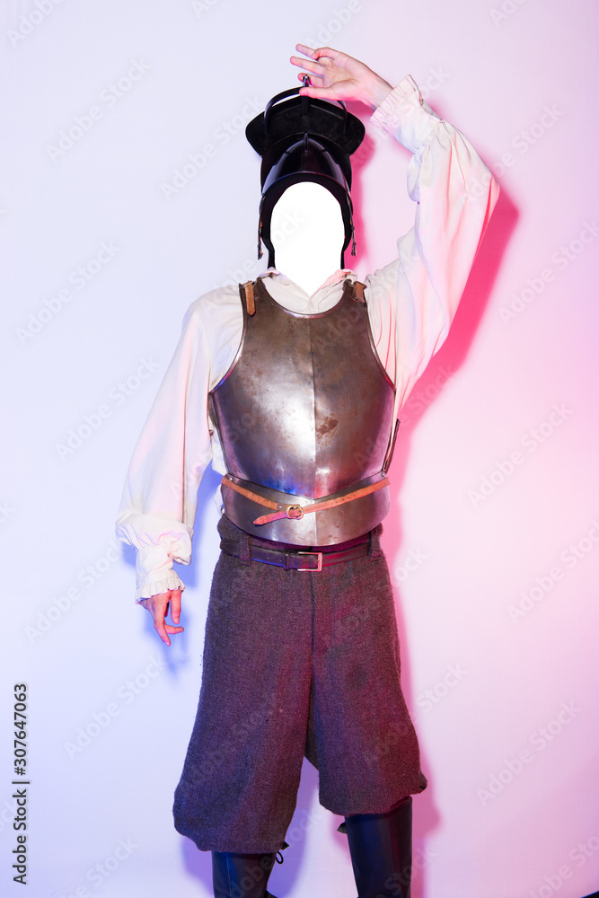 A medieval knight soldier in metal armour and armoured helmet opening ...