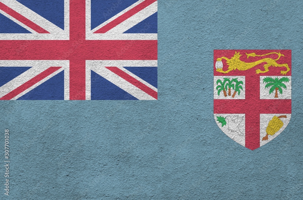Fiji flag depicted in bright paint colors on old relief plastering wall ...