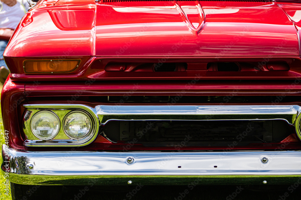 Bright red old classic antique American car half front part, glass ...