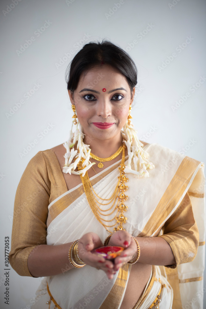 Portrait of an young and attractive Indian woman in white traditional ...