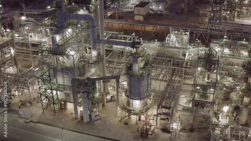Aerial view of petrochemical oil refinery (refining complex) at night ...