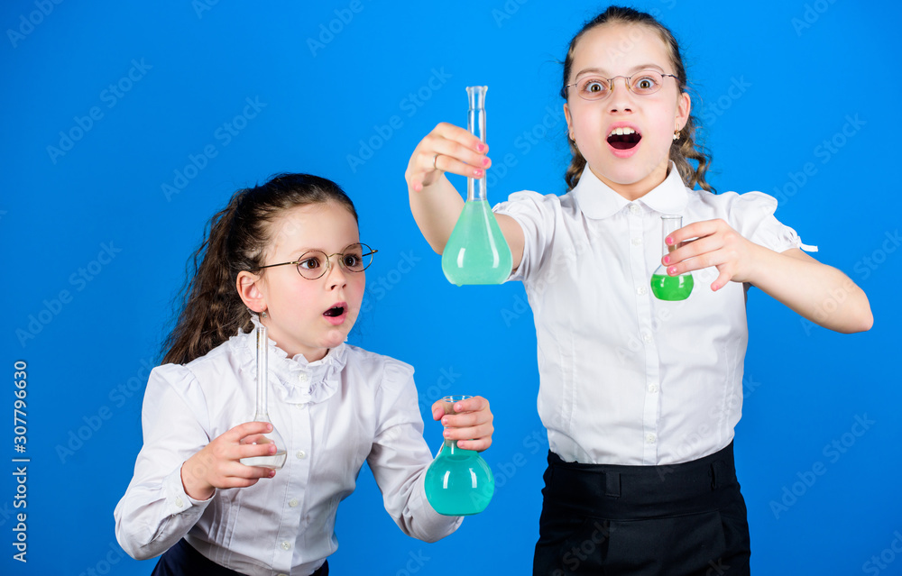Chemistry fun. Knowledge day. Schoolgirl with colorful chemical liquids ...