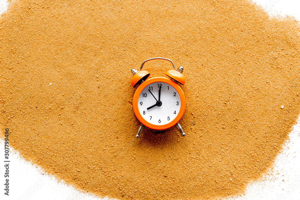 Waste of time concept. Clock on sand on white background top-down Stock ...