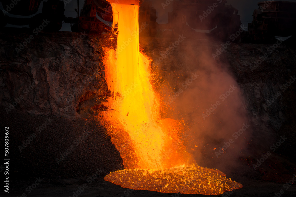 Discharge of metallurgical slag from blast furnaces. Beautiful stream ...