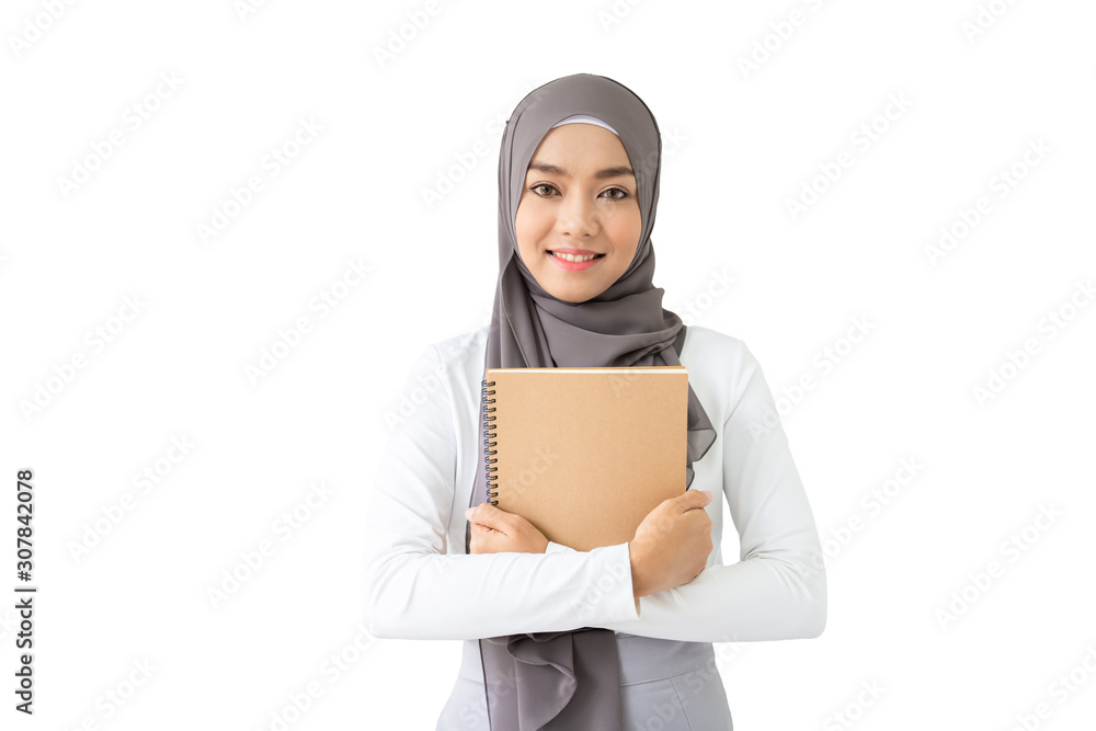 Portrait of beautiful Asian muslim student holding a book and pencile ...