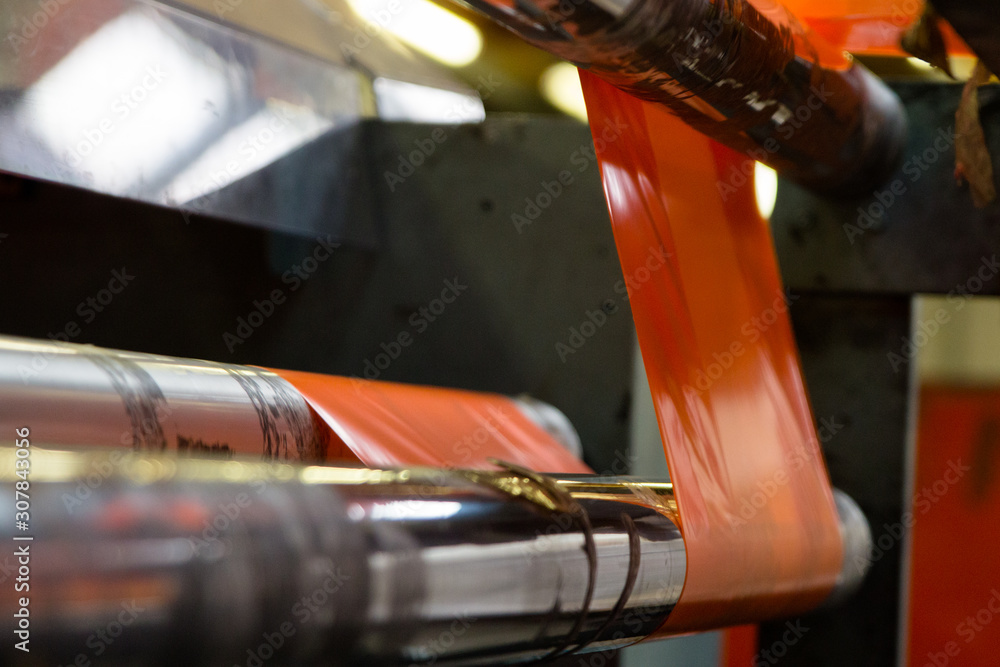 image of the inside workings of a machine with orange high vis plastic ...