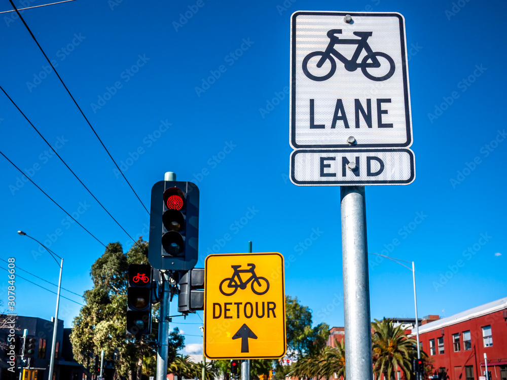 Sign of cycleway detour and end of bike lane near traffic light on ...