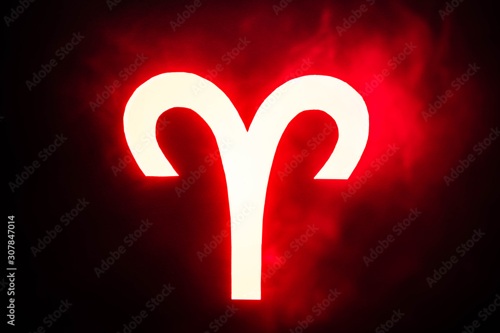Red illuminated Aries zodiac sign with smoke on background Stock Photo ...