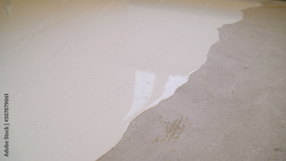 Liquid flooring. Leveling the floor with a liquid composition ...
