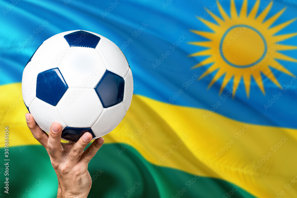 Rwanda soccer concept. National team player hand holding soccer ball ...