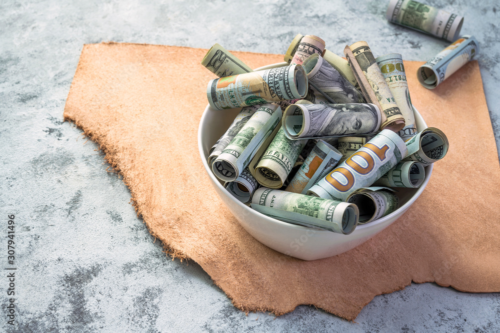 Rolled banknotes of American cash dollar bills of various denominations ...