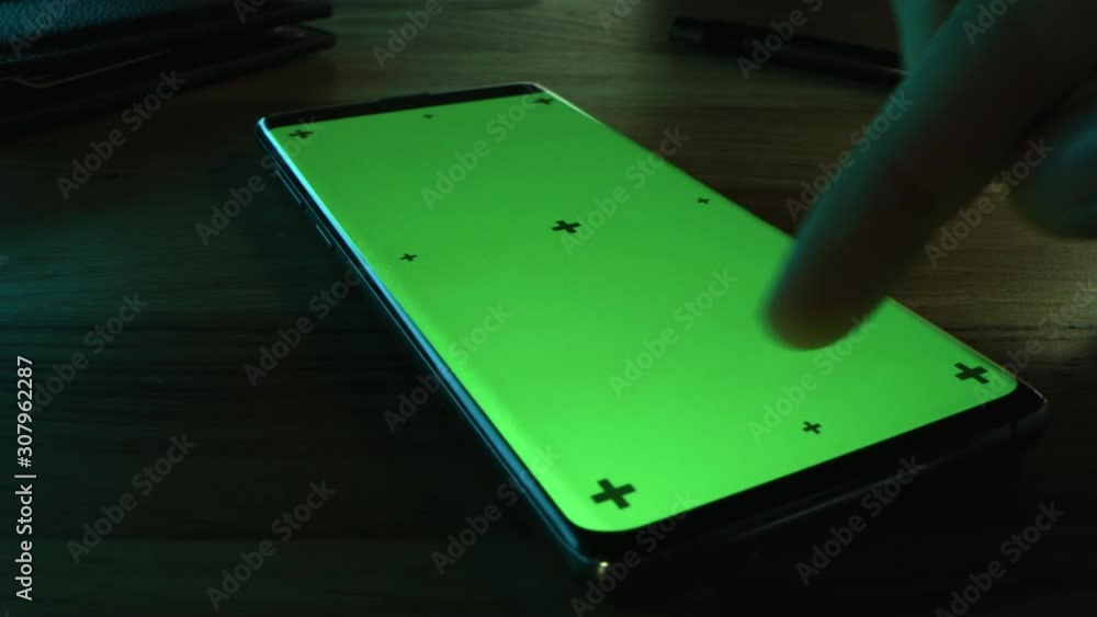 Close-up Macro: Modern Green Mock-up Screen Smartphone Lying on Desk, Person Uses it. Person ...