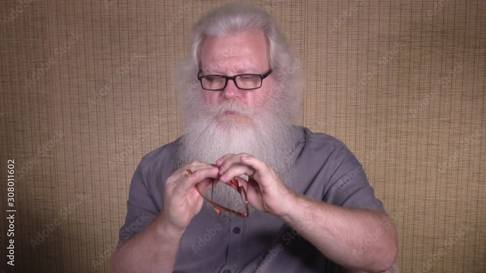 Senior thickset Caucasian man with splendid grey hair and beard is ...