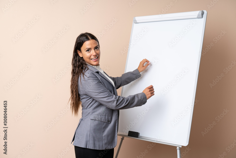 Young woman giving a presentation on white board giving a presentation ...