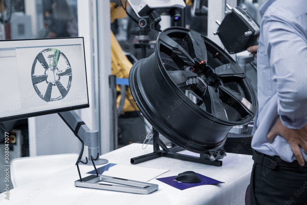 Industrial technician use handheld 3D scanner to scan car wheel Stock ...