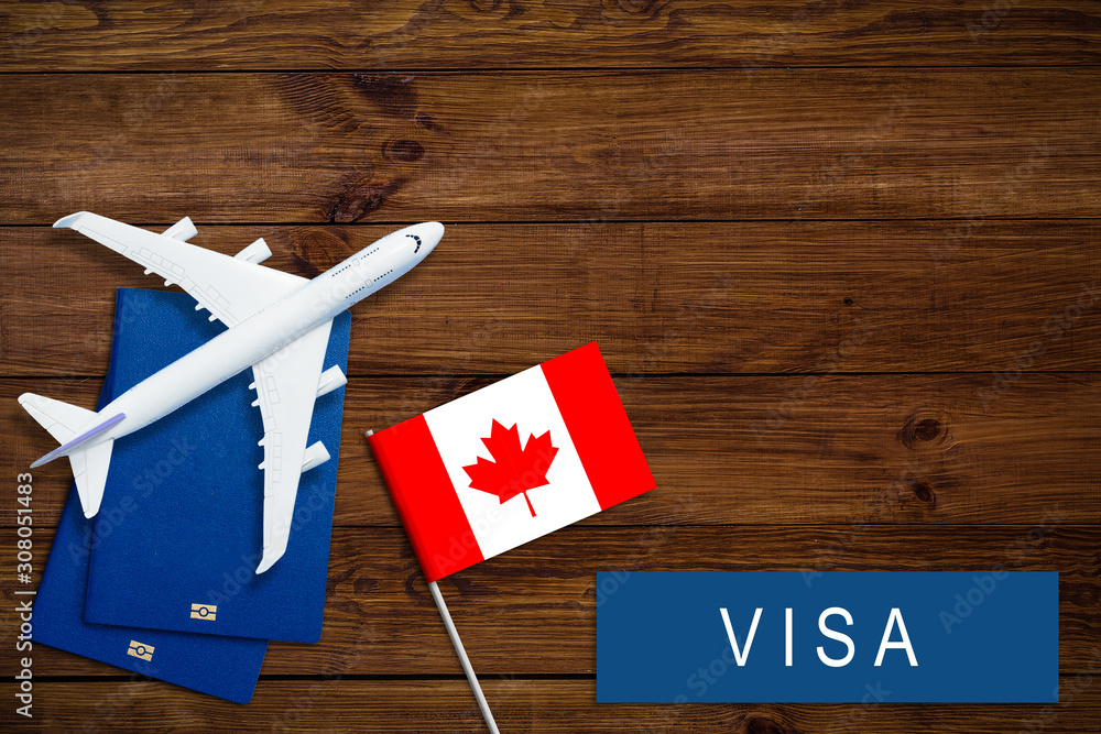 Visa to Canada concept. Text visa near passport cover and canadian flag ...