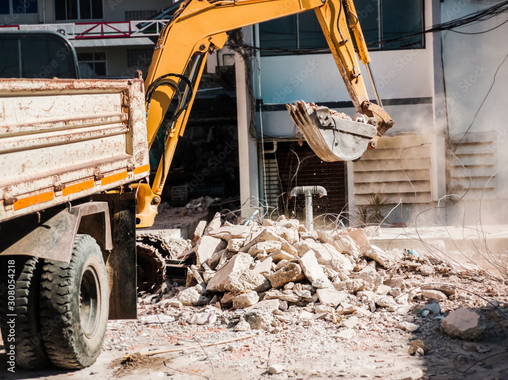 Bulldozer Removes the debris from demolition on the construction site ...