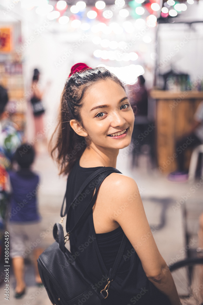 Girl turn face looking back to smile, got big eyes with smiling face ...