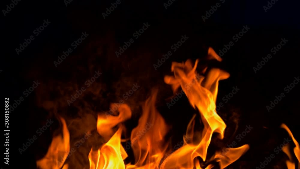 Slow motion fire flame, super slow hot power of bon fire on dark night ...