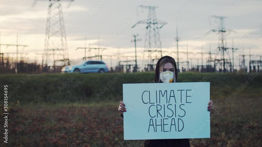 Blonde girl in black suit and white protection mask standing near a ...