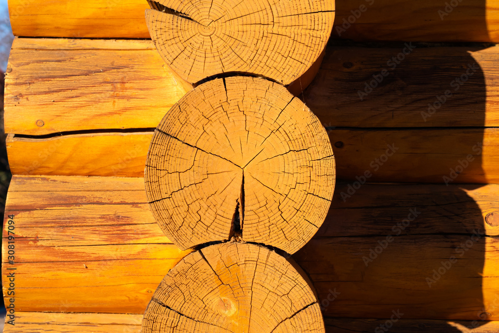 Wood wall is made of beams. Wood textures. Ends of round wall logs ...
