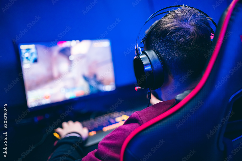 Professional gamer playing online games tournaments pc computer with ...