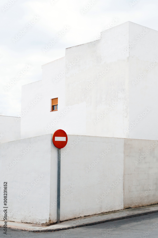 Street stop sign placed on minimalistic whitewashed building background ...