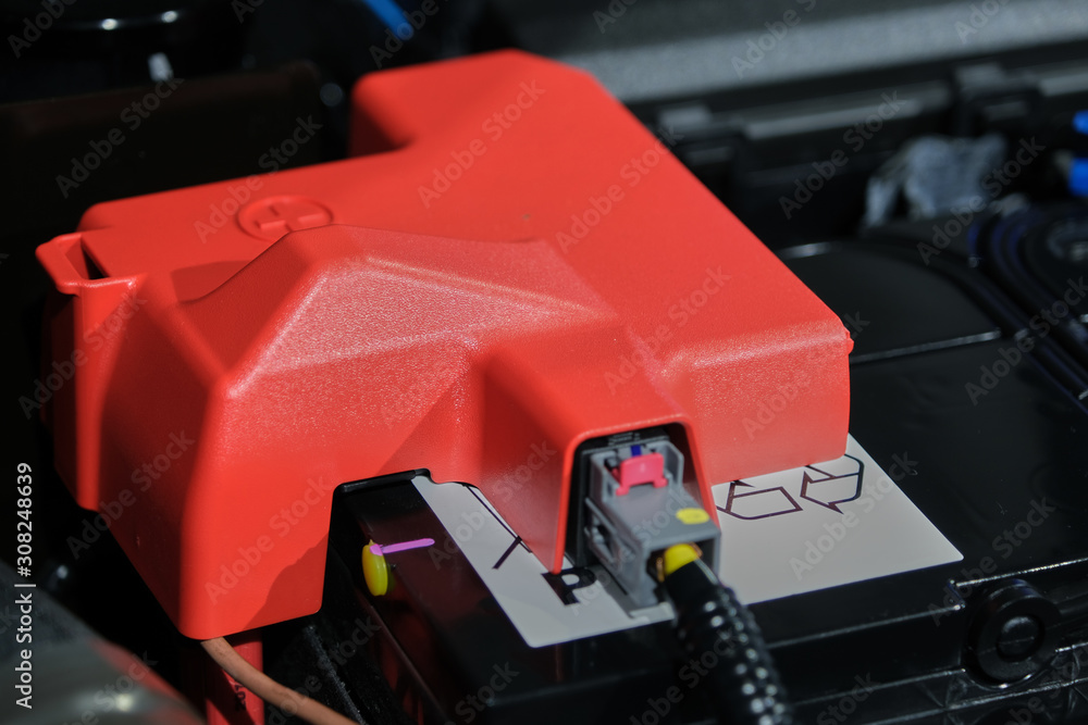 plastic cover of the positive battery cell tip with the red plus symbol ...